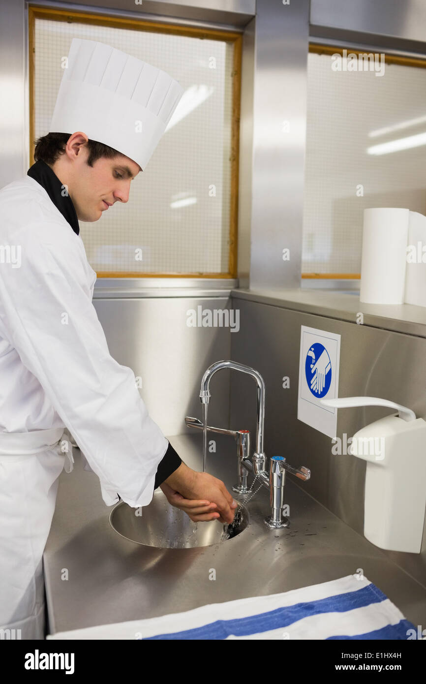 Concentrated chef washing hands Stock Photo - Alamy