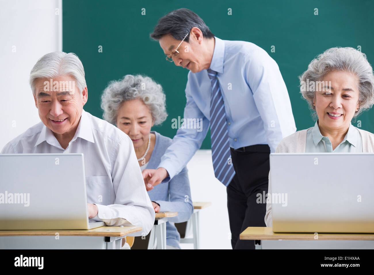 Senior adults having computer class at school Stock Photo - Alamy