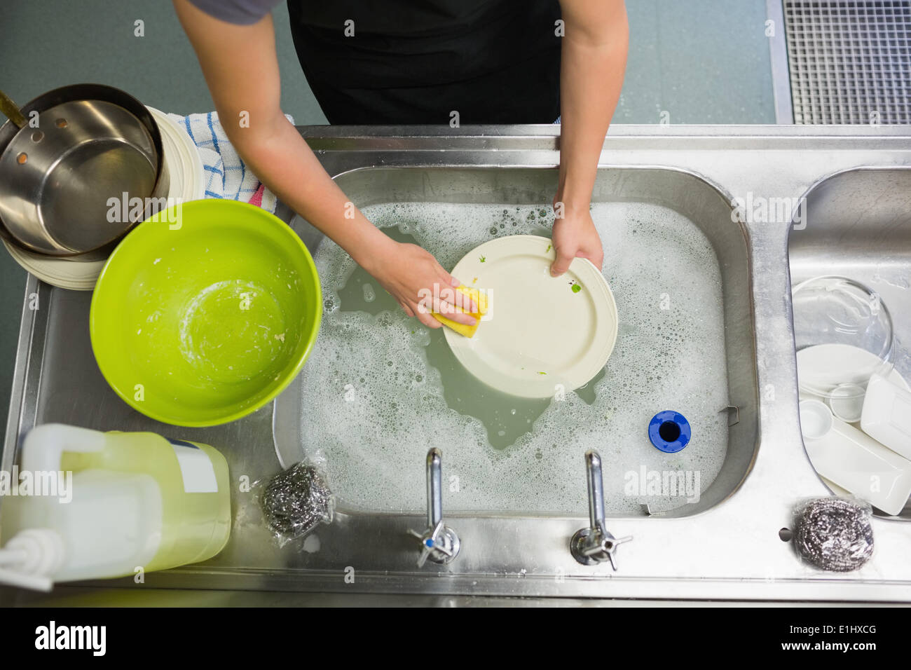 Woman busy washing dishes in hi-res stock photography and images - Alamy