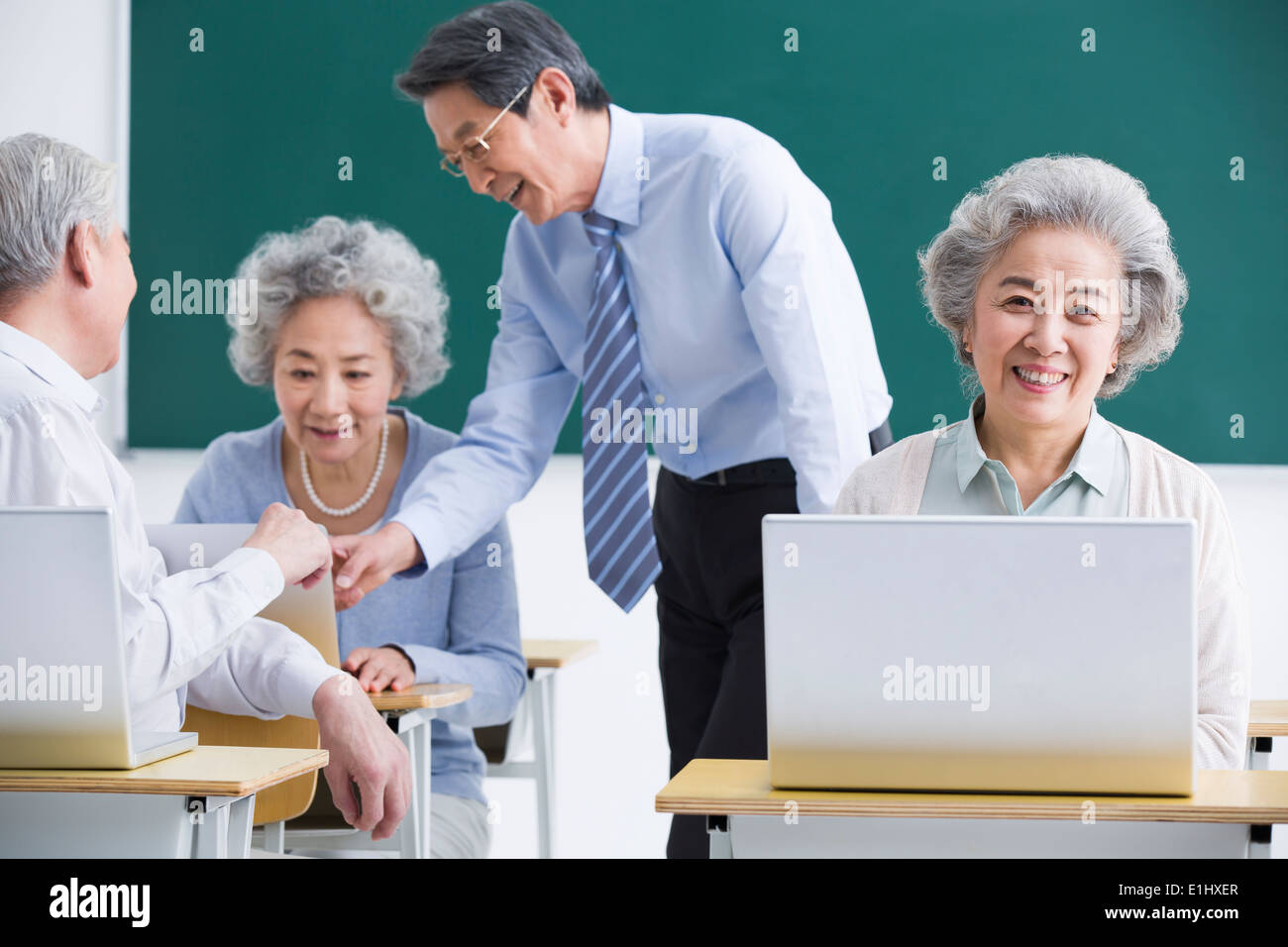 Senior adults having computer class at school Stock Photo - Alamy
