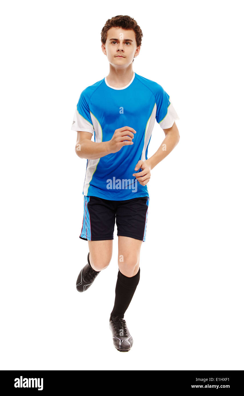 Full length of a teenage soccer player running towards the camera ...