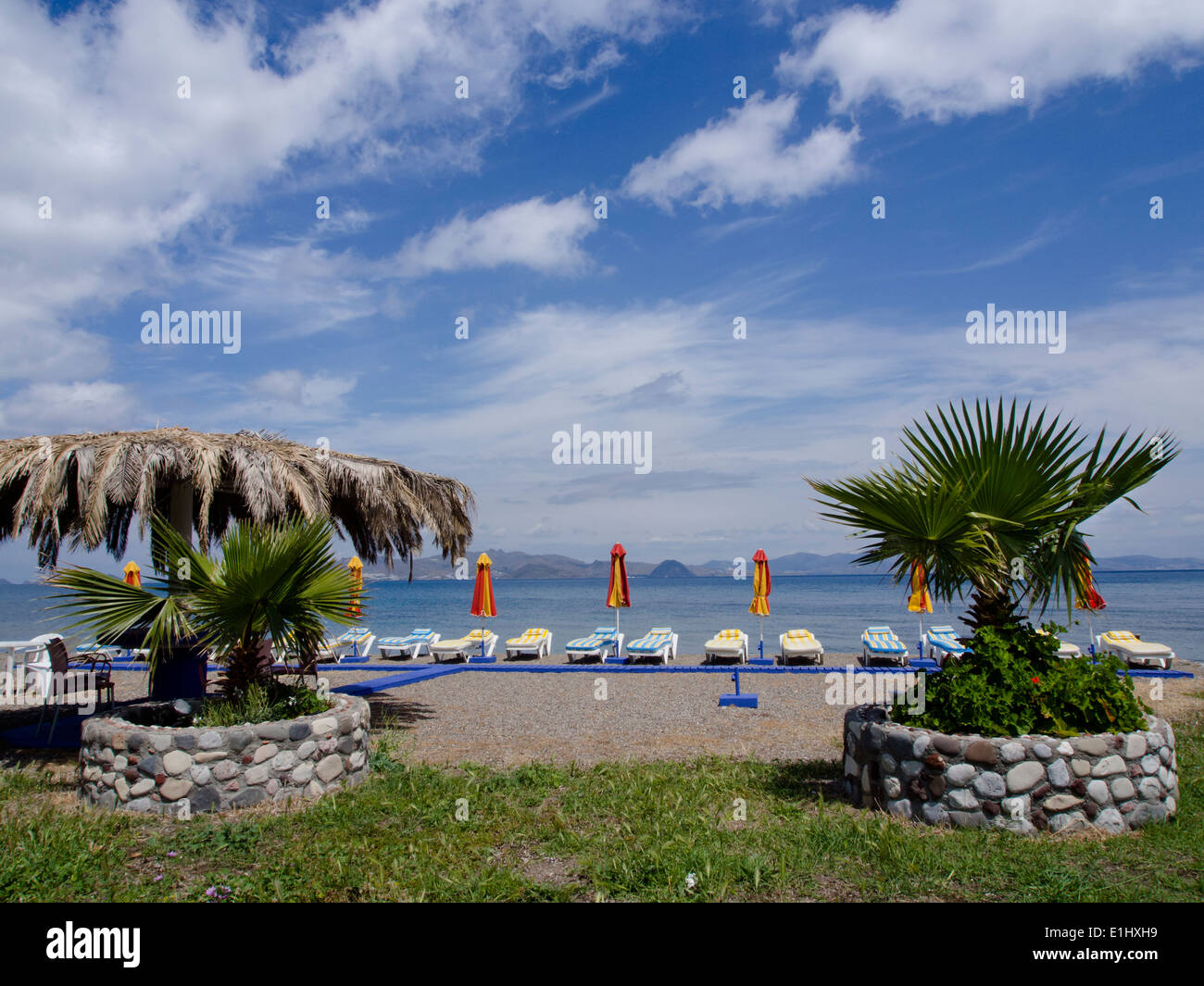 View to Turkey from Kos Island through palm trees and sun loungers ...