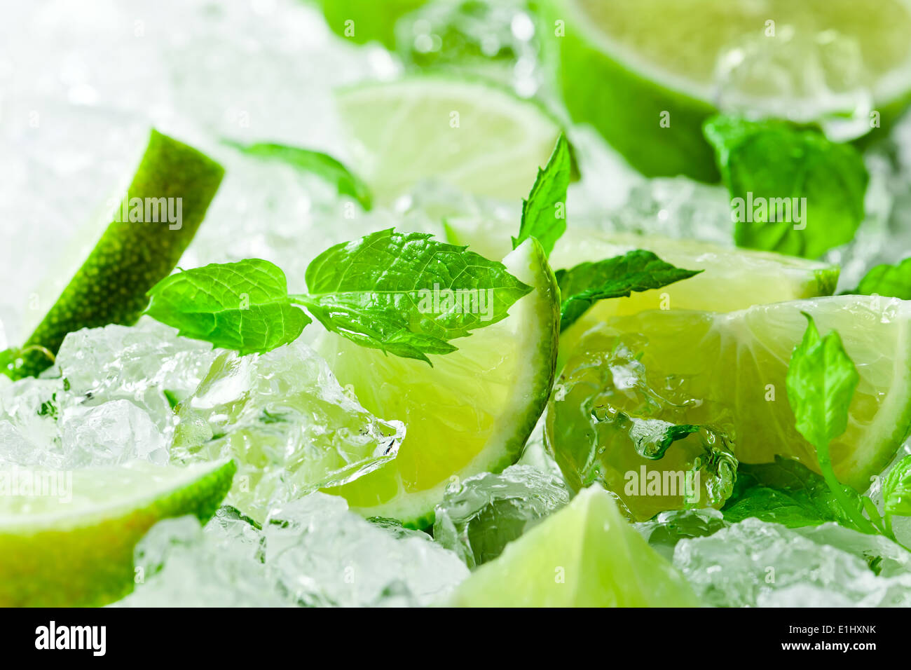 lime pieces and leaves of mint with ice Stock Photo - Alamy