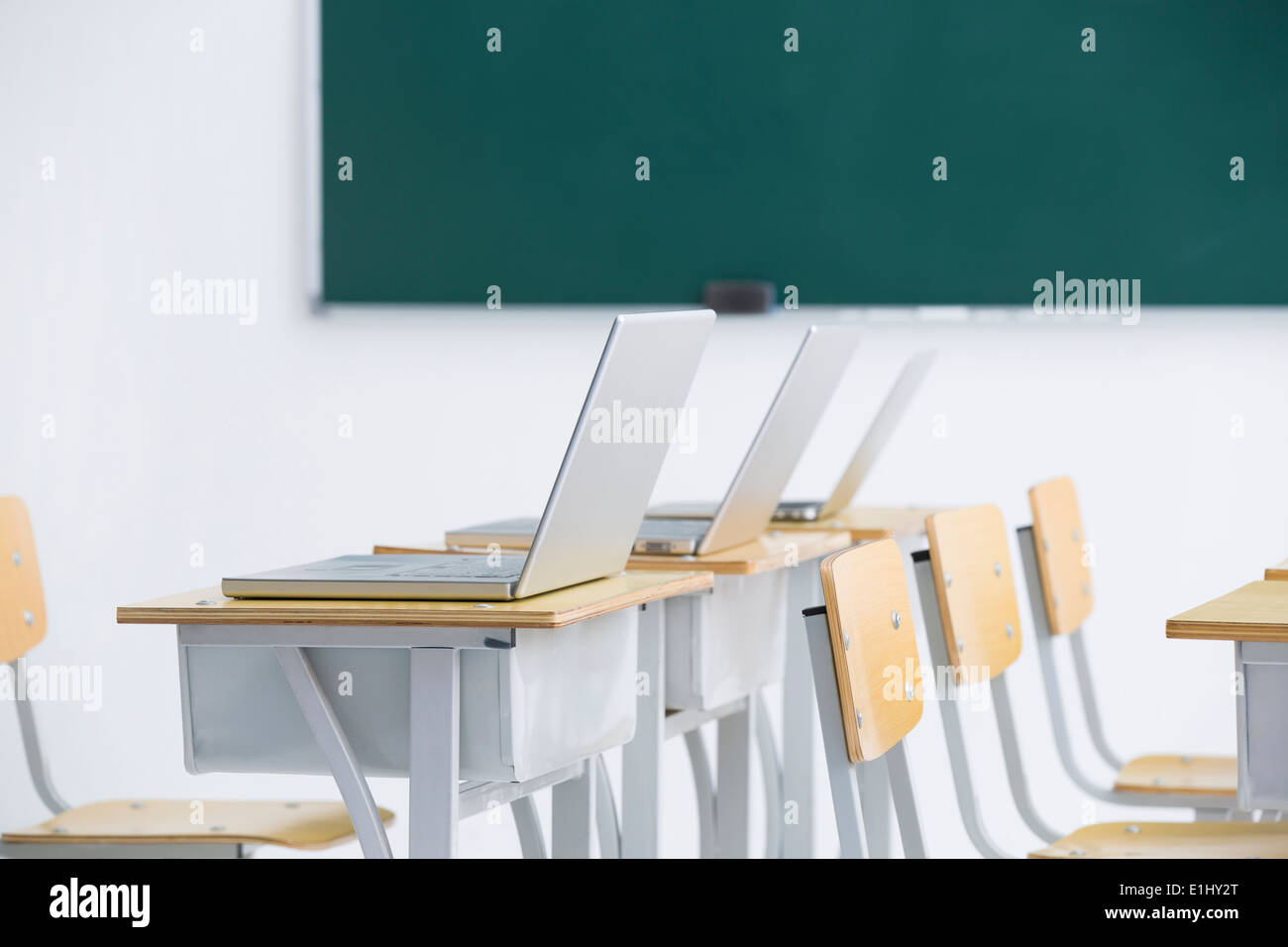 Laptops in classroom Stock Photo - Alamy