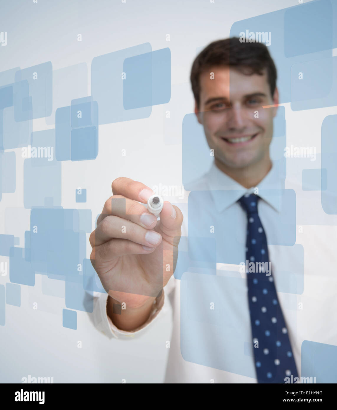 Smiling businessman about to write something Stock Photo - Alamy
