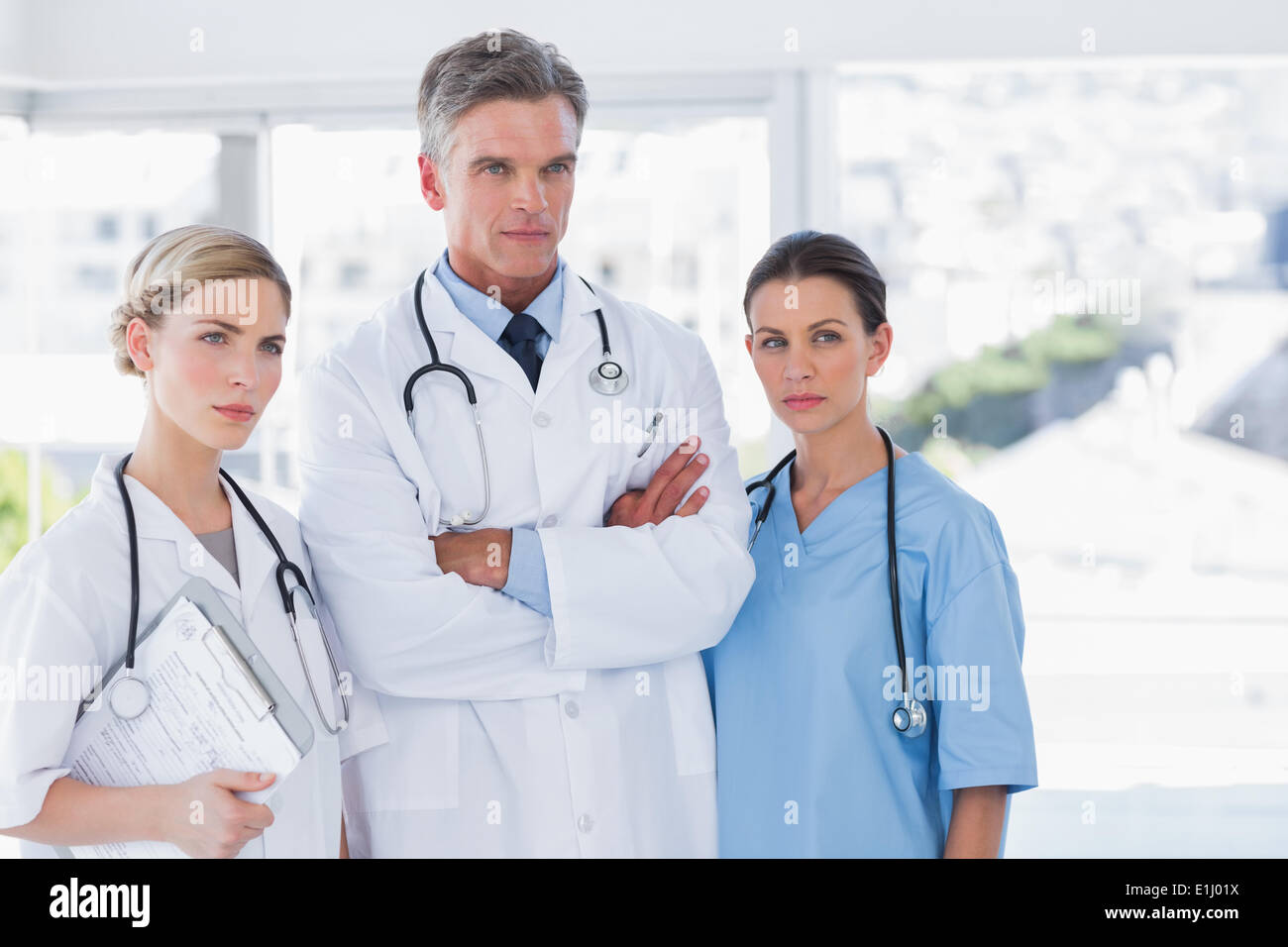 Three serious doctors Stock Photo - Alamy
