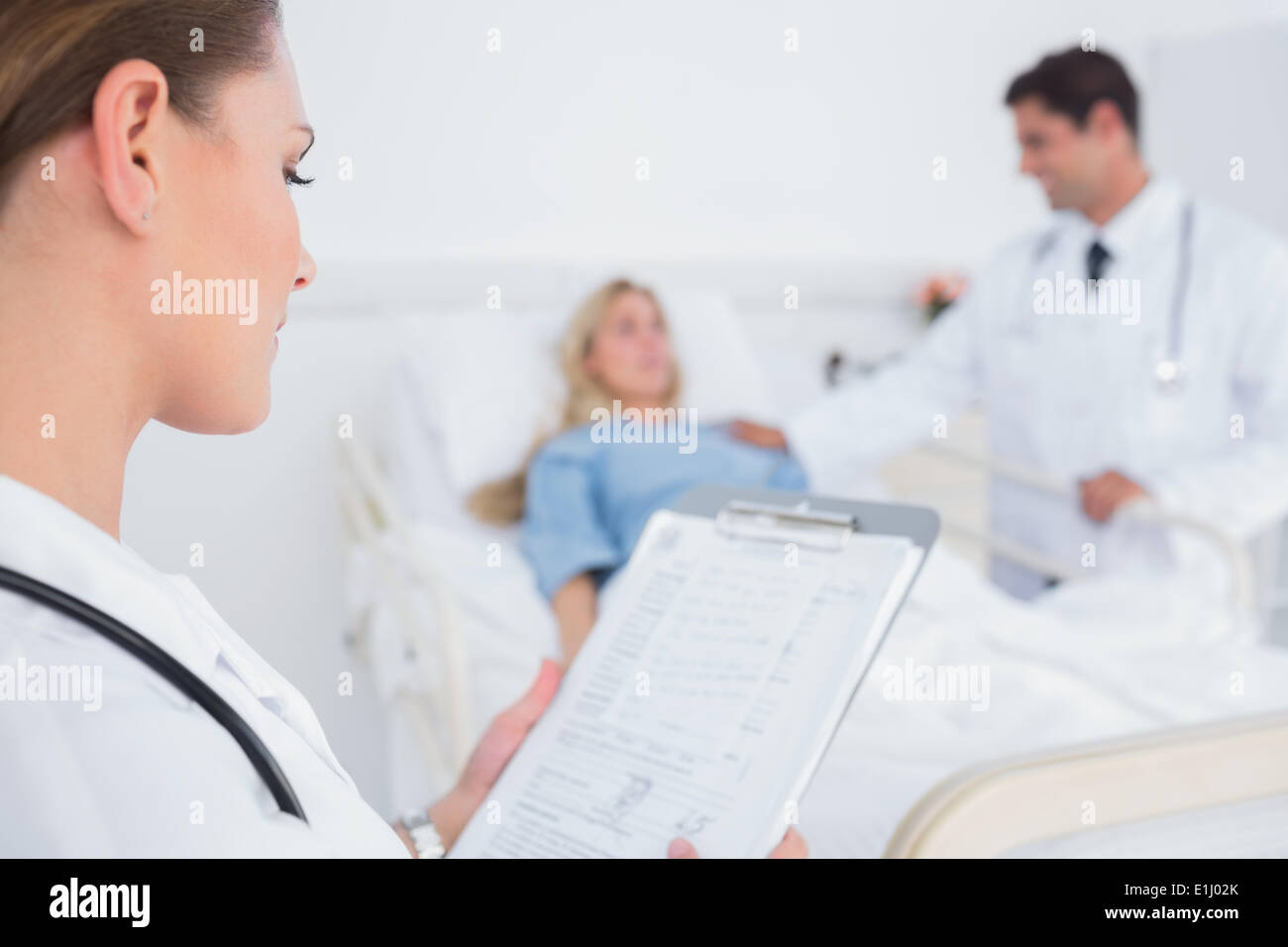 Young blonde woman doctor reading hi-res stock photography and images ...