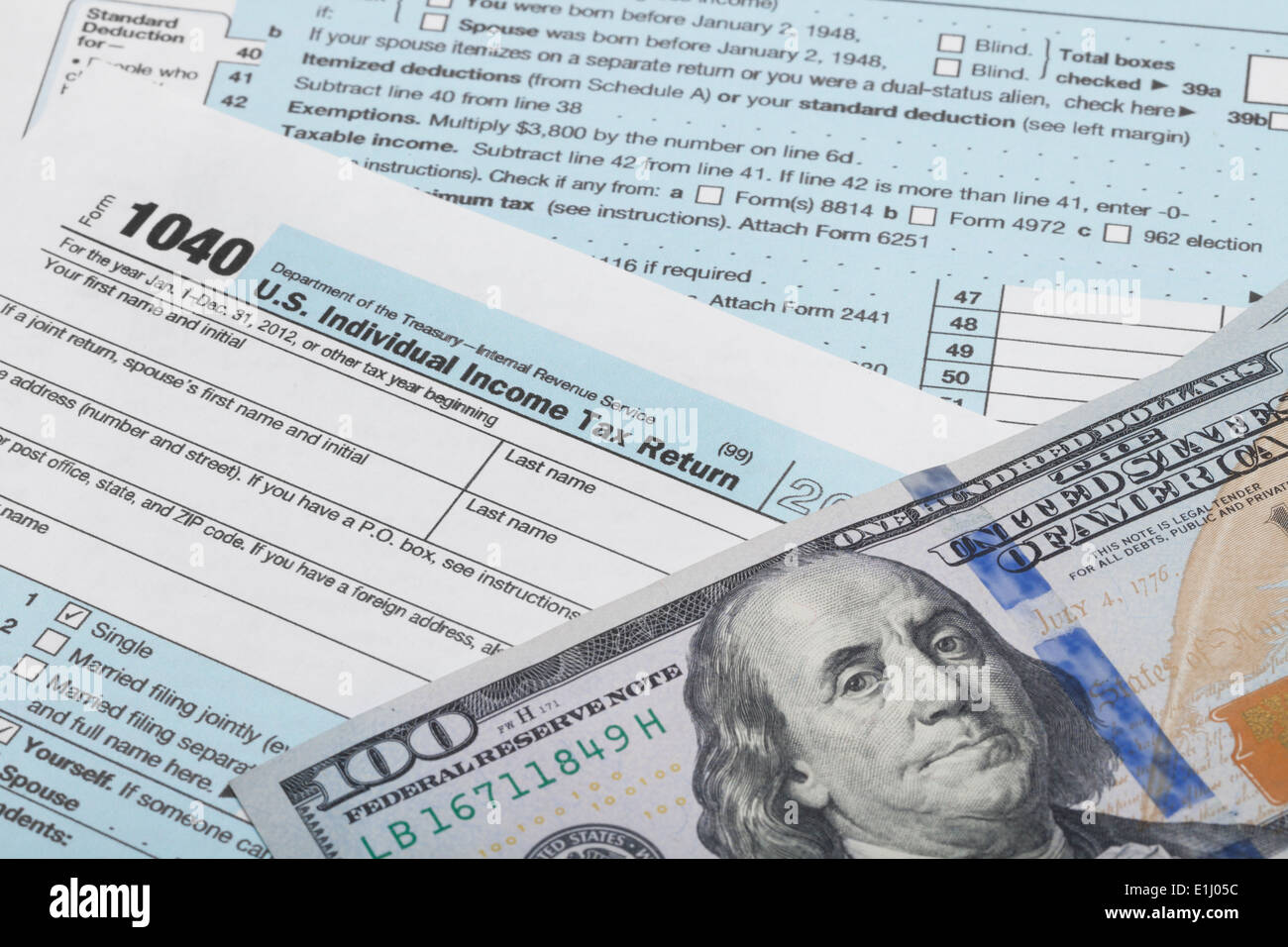Tax Form 1040 with 100 dollars banknote Stock Photo - Alamy
