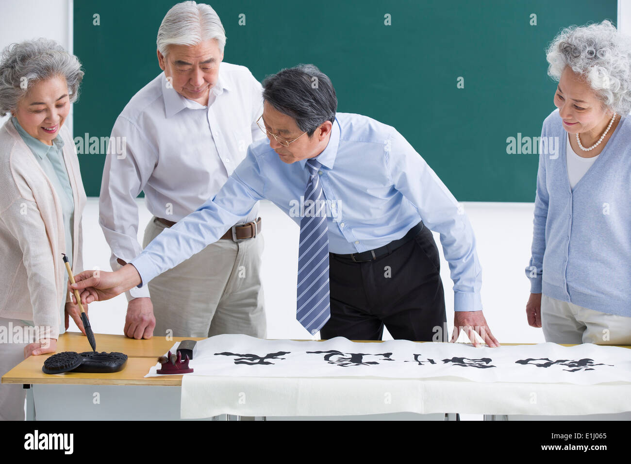 Senior adults having calligraphy class at school Stock Photo - Alamy