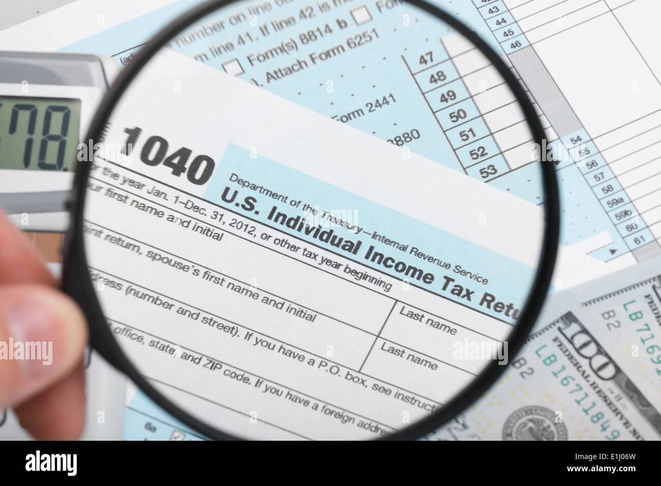 Tax Form 1040 with magnifying glass Stock Photo - Alamy