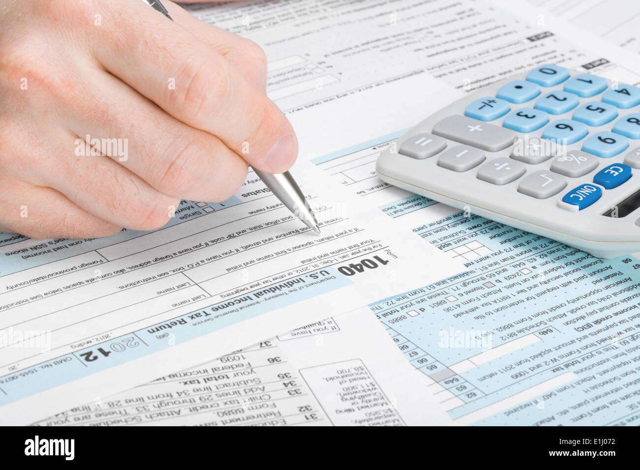 Tax Form 1040 - man filling out tax form Stock Photo - Alamy
