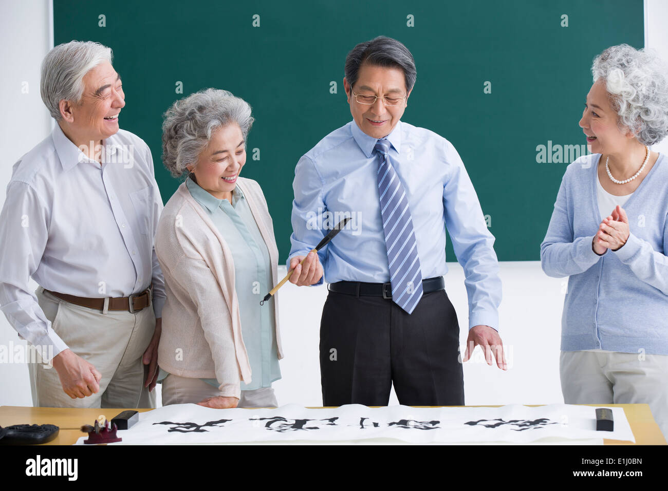 Senior adults having calligraphy class at school Stock Photo - Alamy