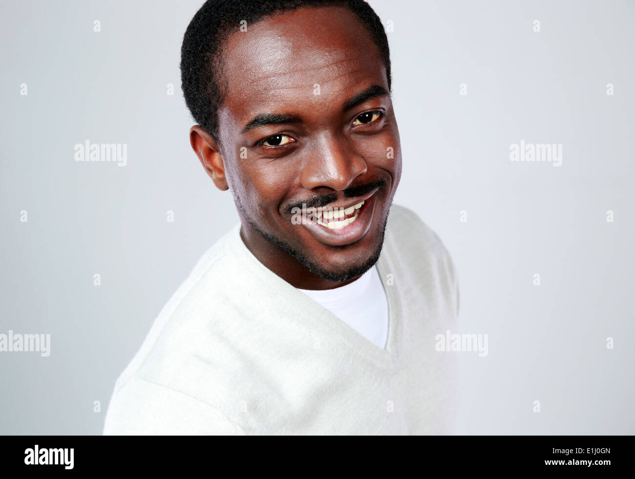 Smiling positive handsome african hi-res stock photography and images ...