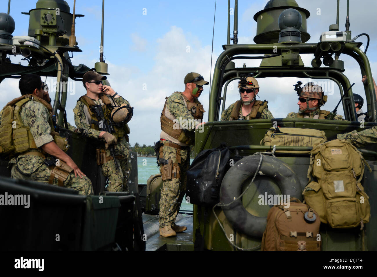 U.S. Sailors perform a hip tow maneuver in which two boats are tied ...