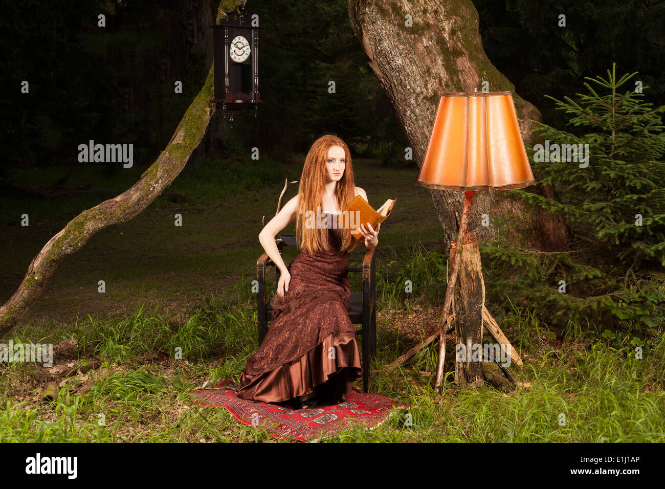 Young woman with evening dress sitting on chair in park by night Stock ...