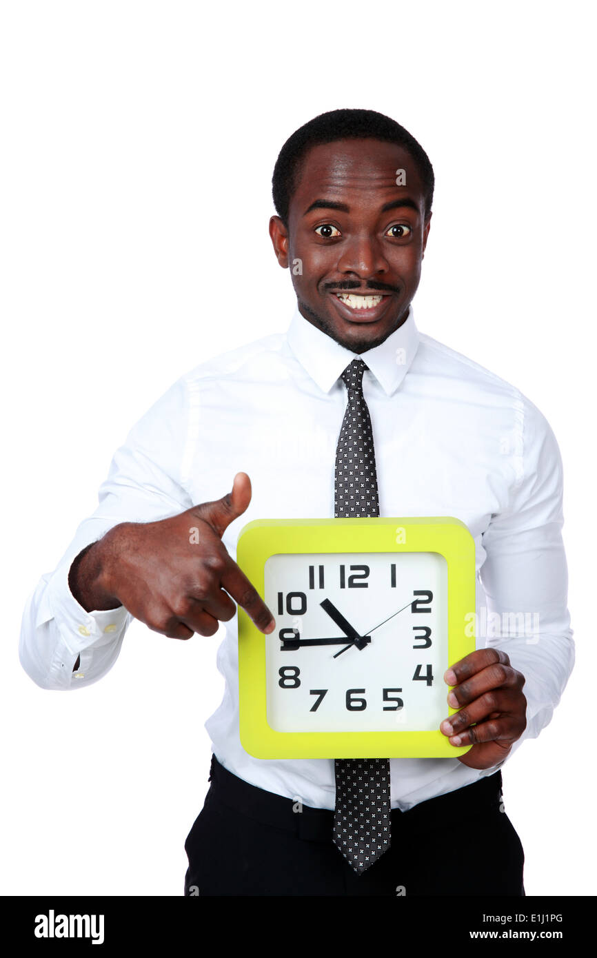 Time is money! Handsome african man holding a clock and showing on it ...