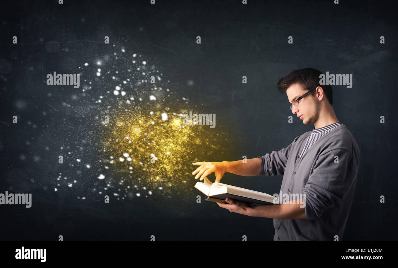 Young guy reading a magical book Stock Photo - Alamy