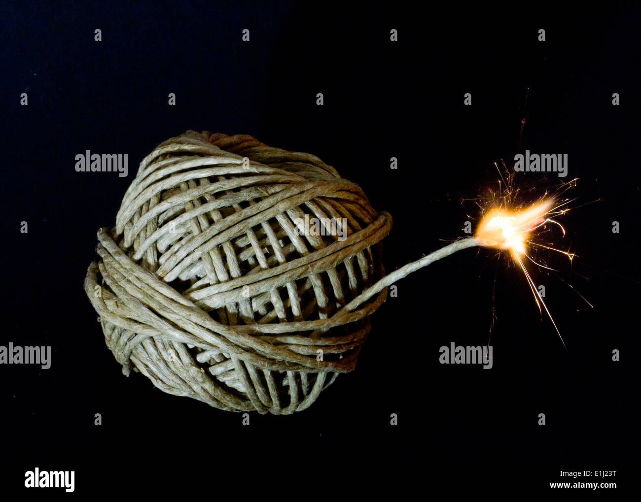 Burning cord in front of black background Stock Photo - Alamy