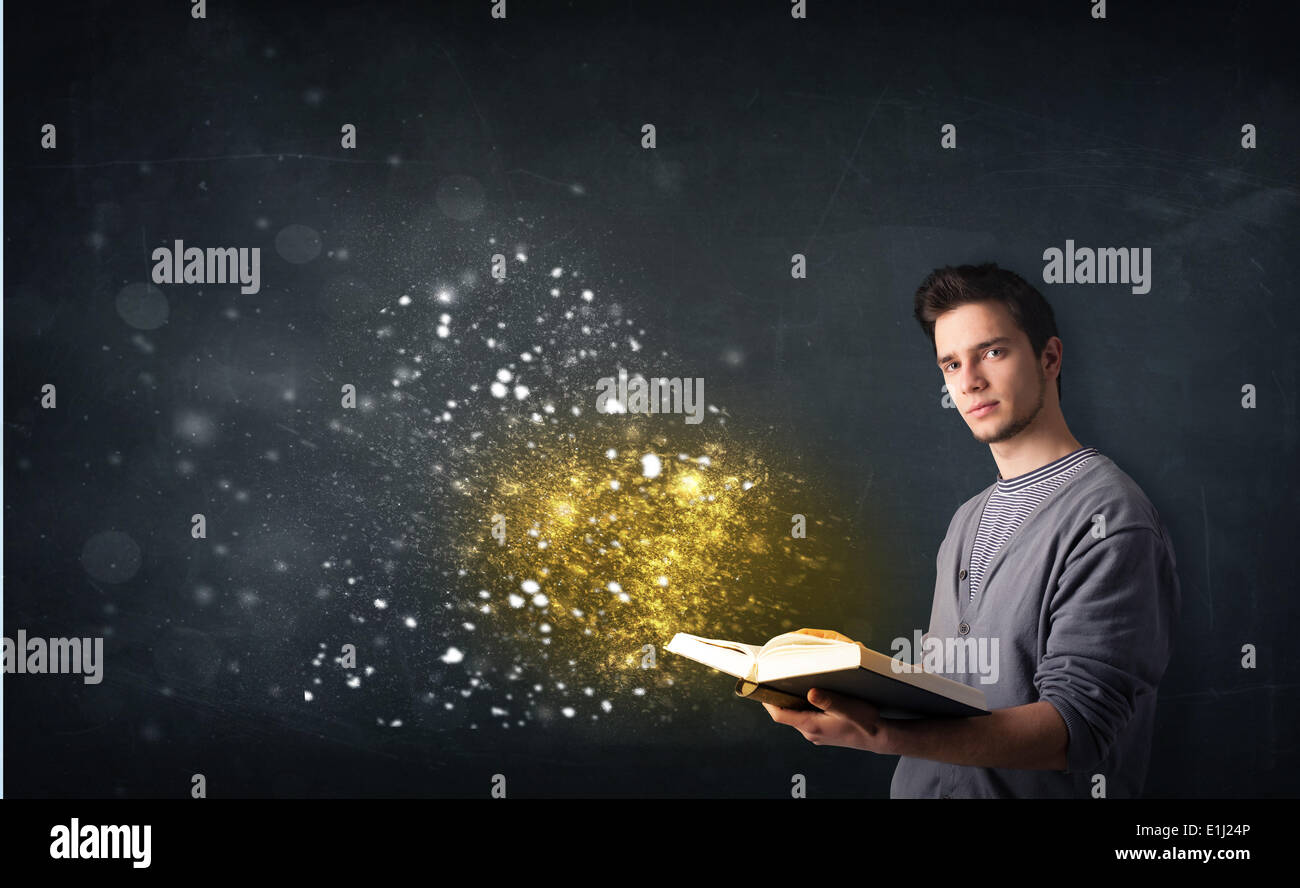Young guy reading a magical book Stock Photo - Alamy