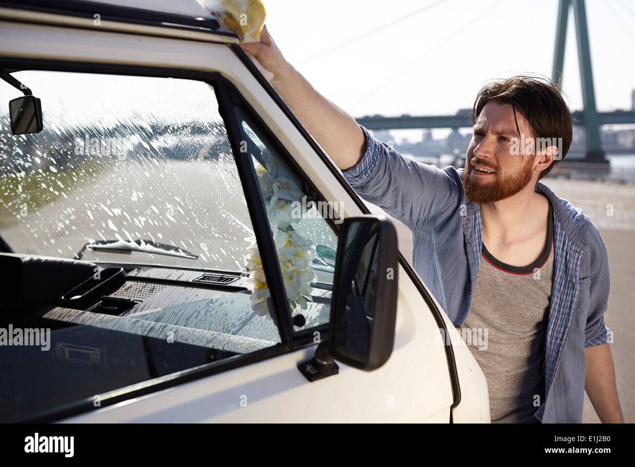 Man washing front window of a car Stock Photo - Alamy