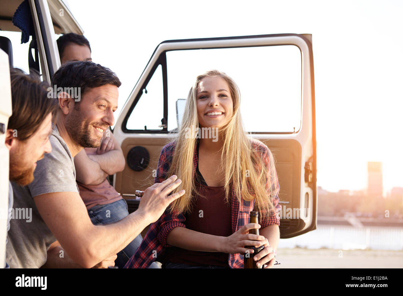 Happy friends celebrating at minivan Stock Photo - Alamy