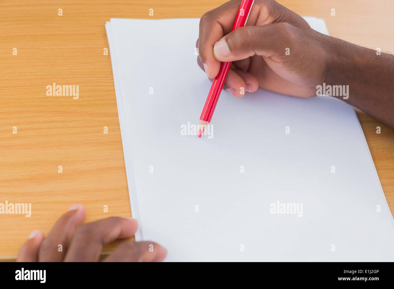 Man drawing with a red pencil Stock Photo - Alamy