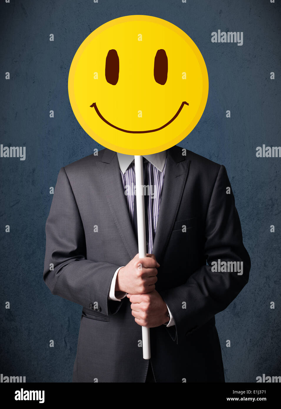 Businessman holding a smiley face emoticon Stock Photo - Alamy