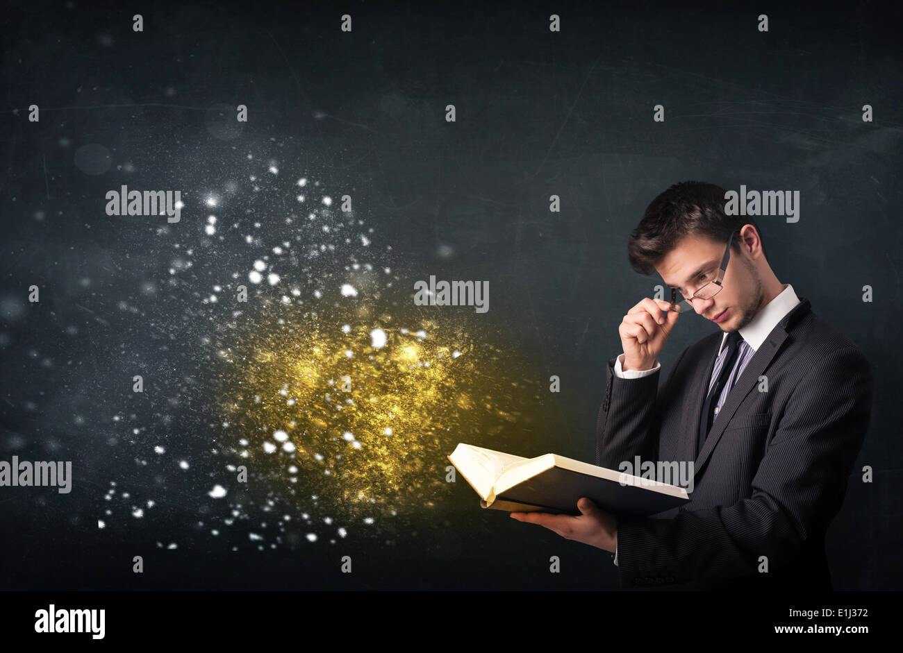 Young guy reading a magical book Stock Photo - Alamy