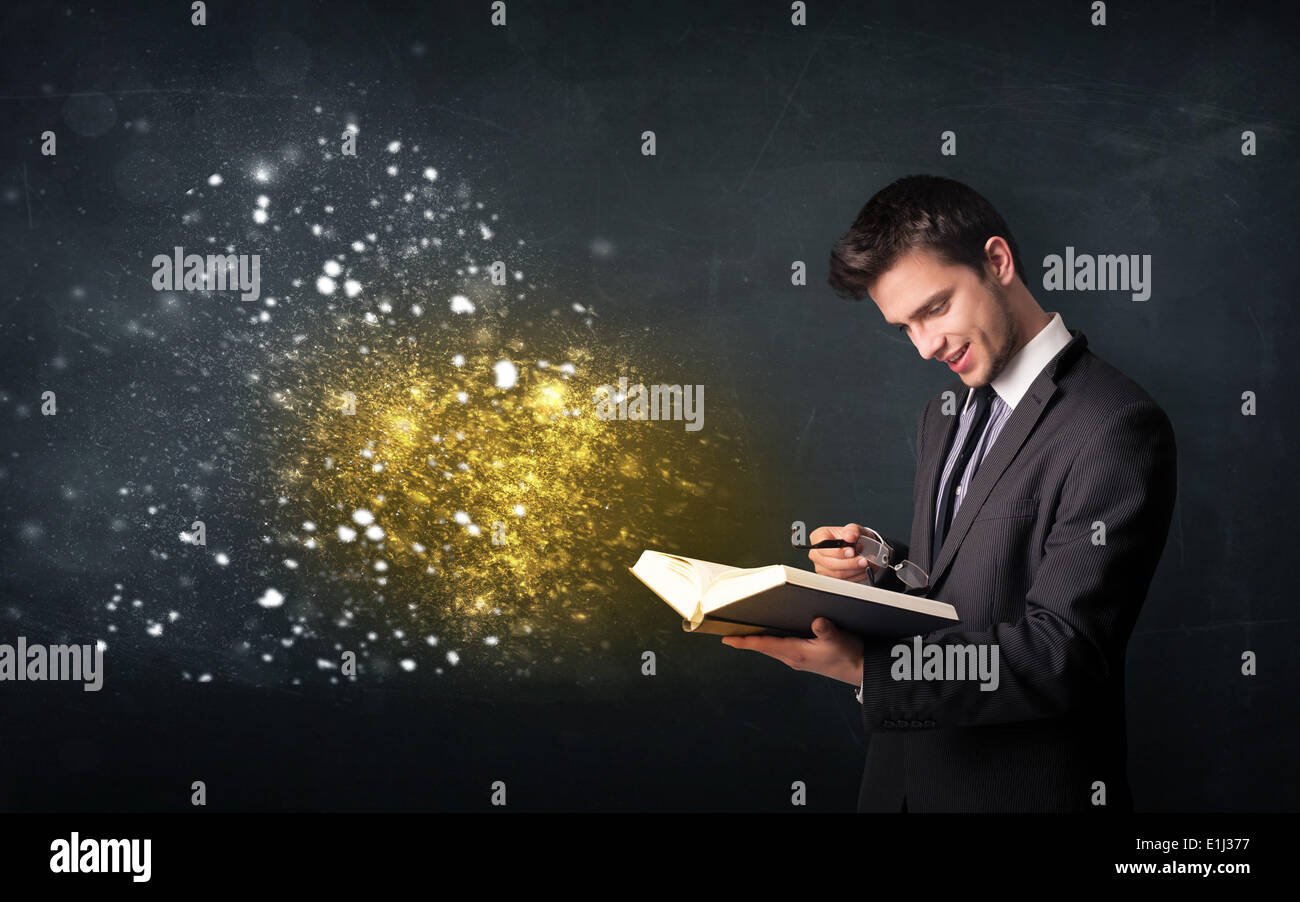 Young guy reading a magical book Stock Photo - Alamy