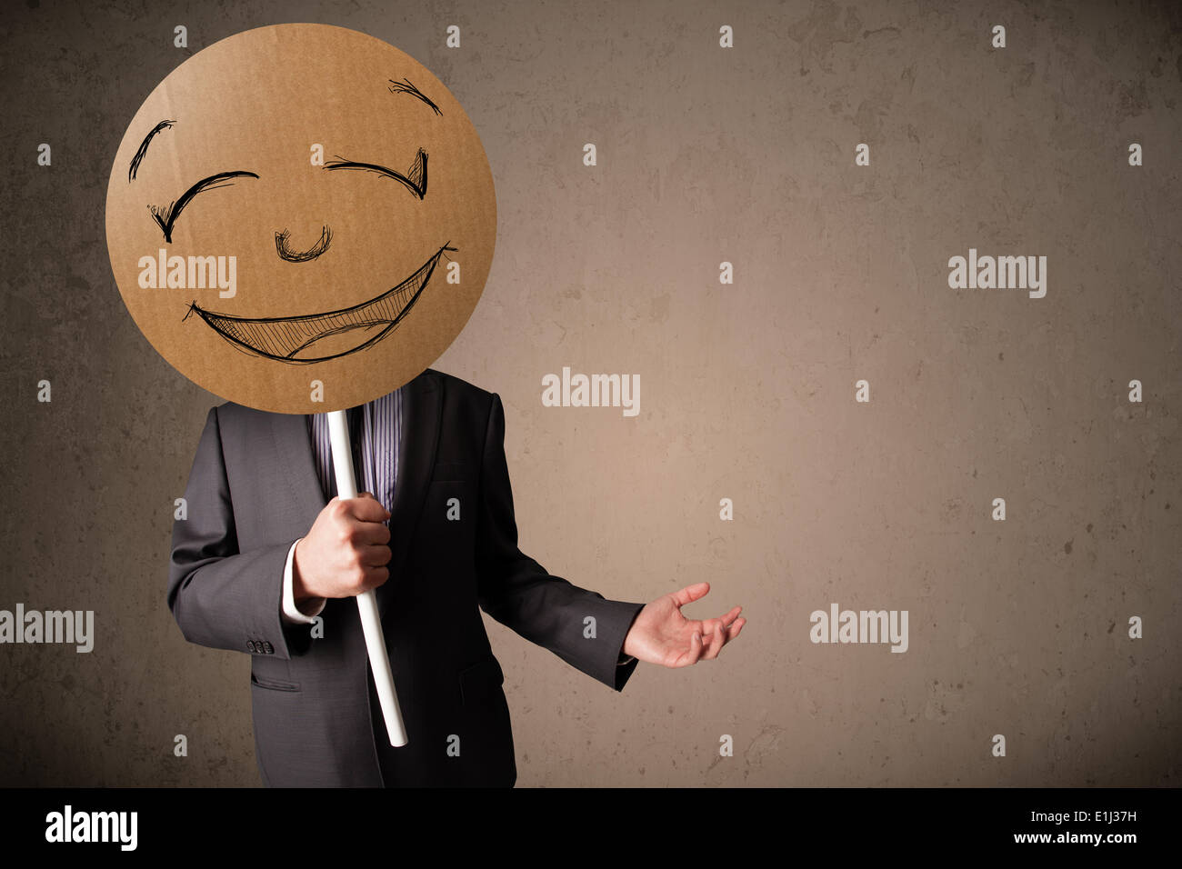 Businessman holding a smiley face board Stock Photo - Alamy