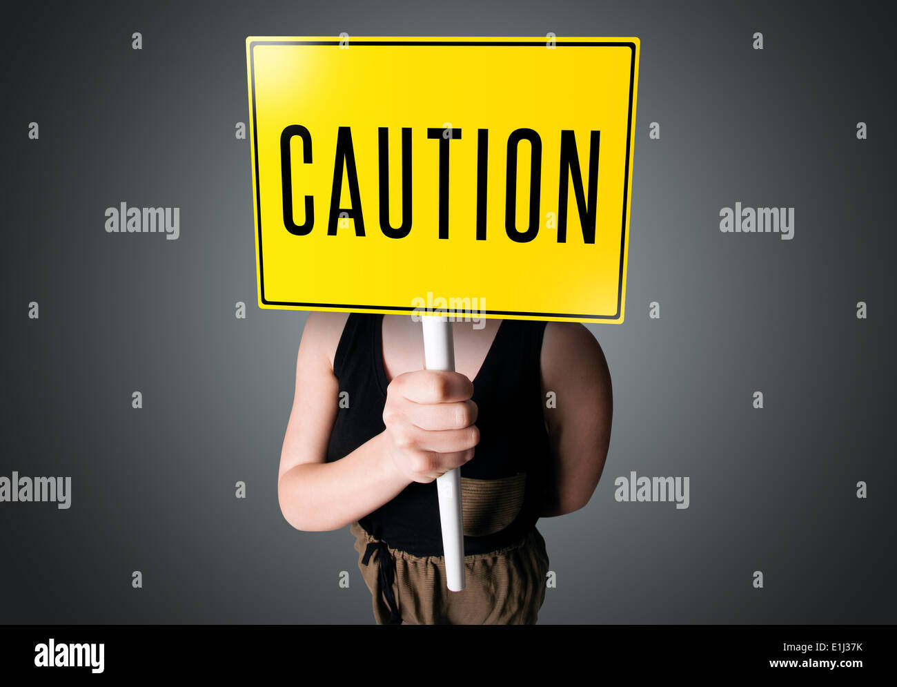 Young woman holding a caution sign Stock Photo - Alamy