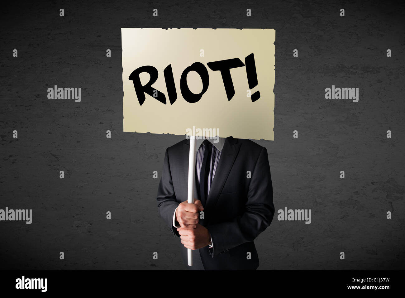 Businessman holding a protest sign Stock Photo - Alamy