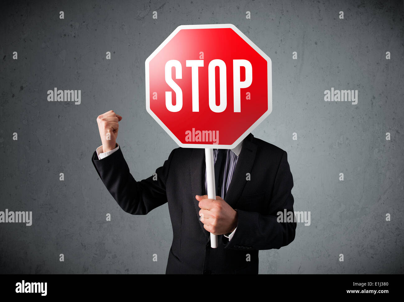 Businessman holding a stop sign Stock Photo - Alamy