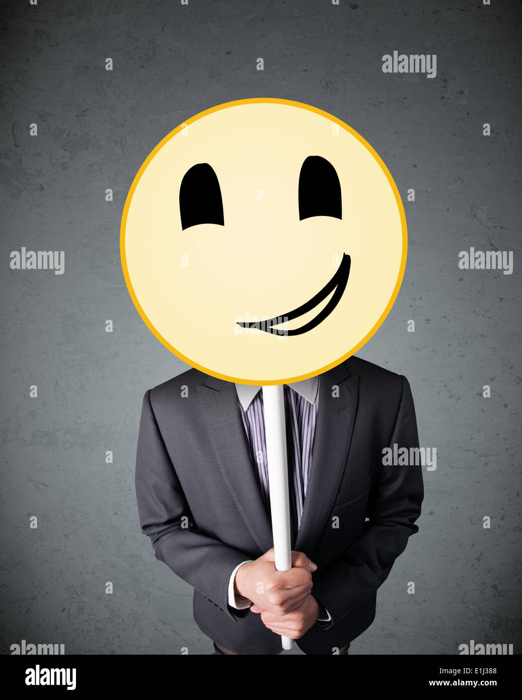 Businessman holding a smiley face emoticon Stock Photo - Alamy