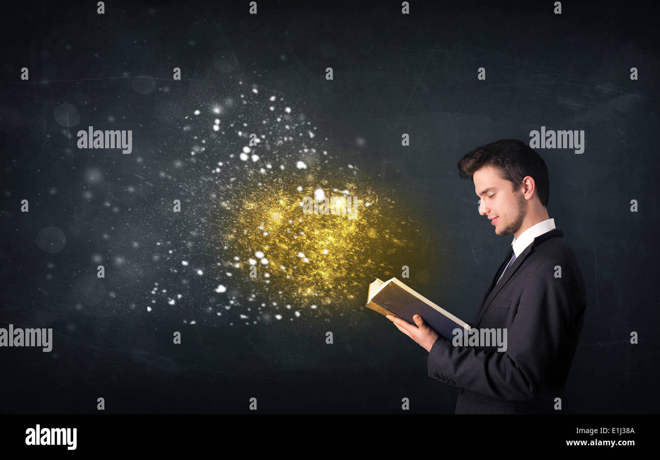 Young guy reading a magical book Stock Photo - Alamy
