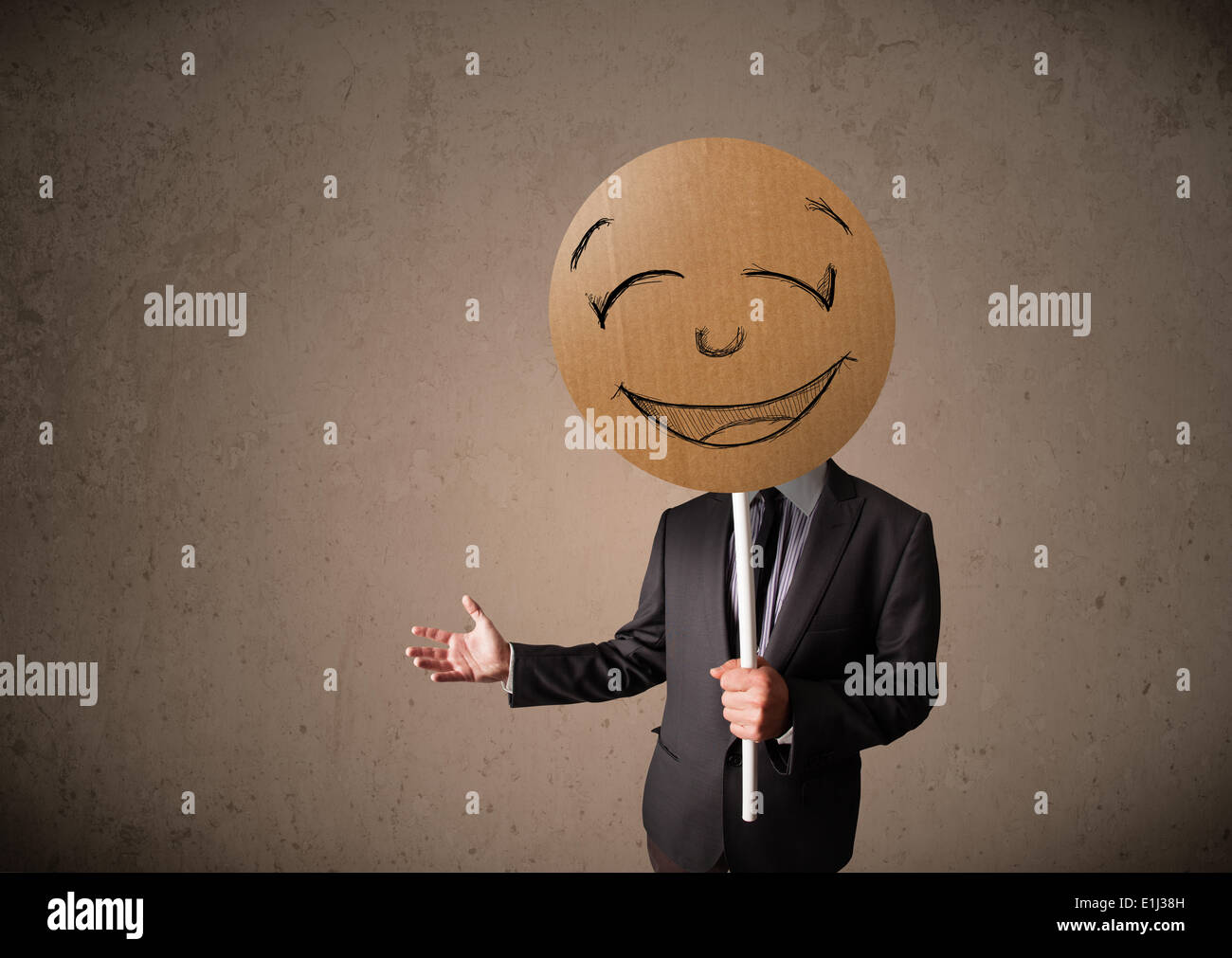 Businessman holding a smiley face board Stock Photo - Alamy