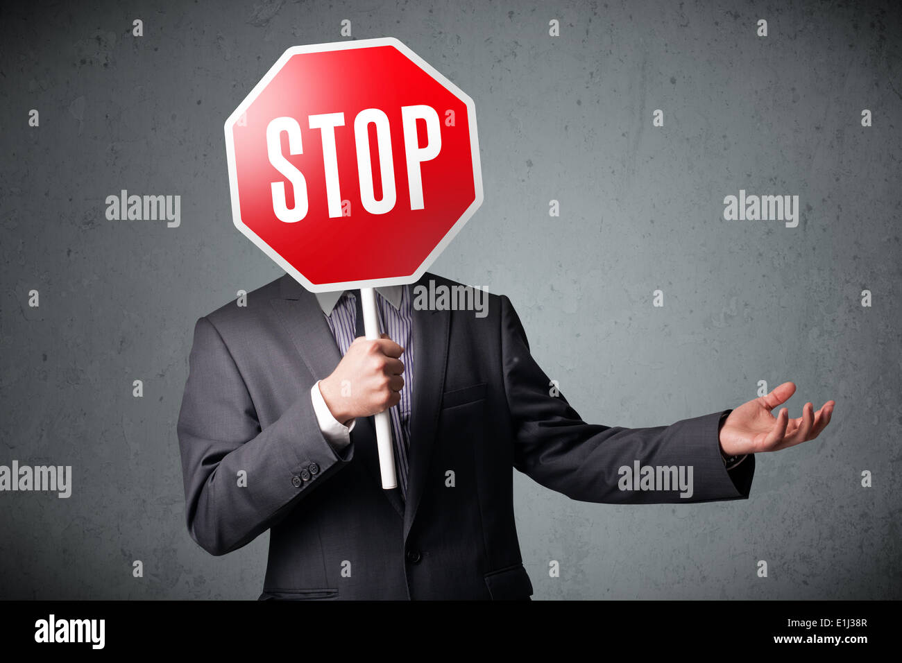 Businessman holding a stop sign Stock Photo - Alamy