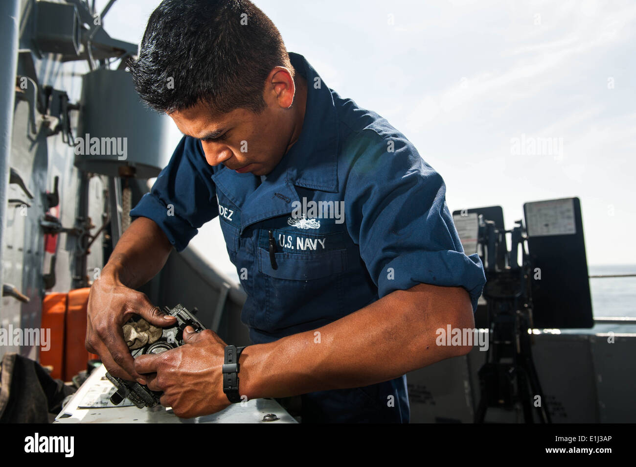 Gunner's Mate Seaman Daniel Hernandez, from San Antonio, performs ...