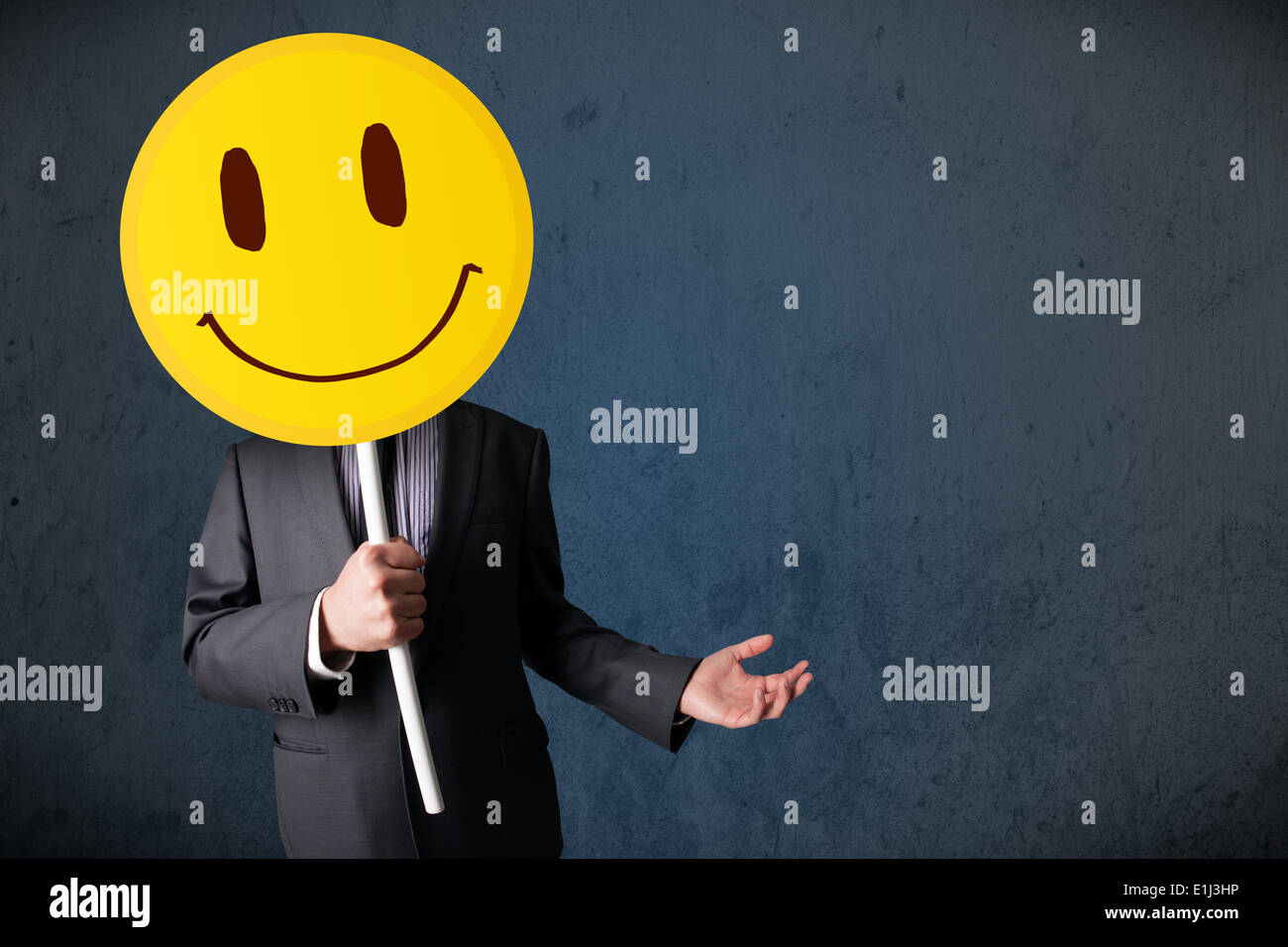Businessman holding a smiley face emoticon Stock Photo - Alamy