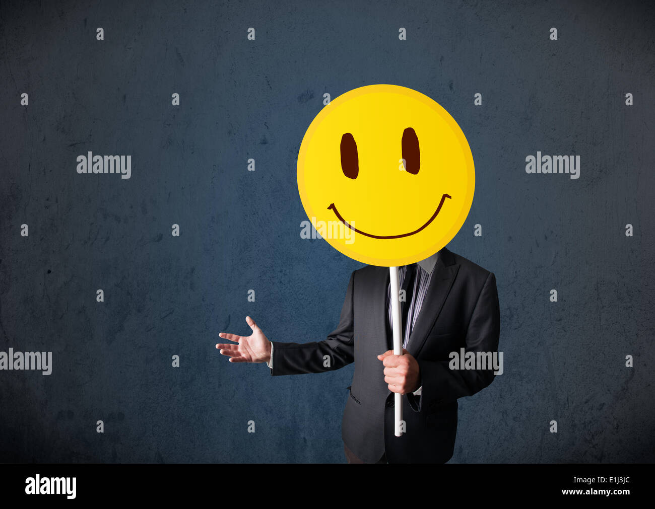 Businessman holding a smiley face emoticon Stock Photo - Alamy