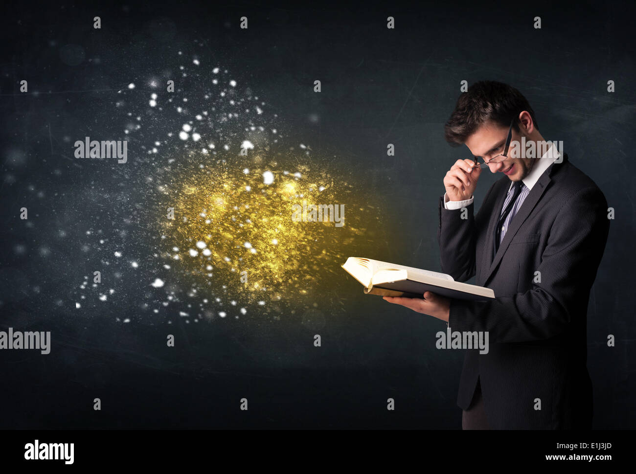 Young guy reading a magical book Stock Photo - Alamy