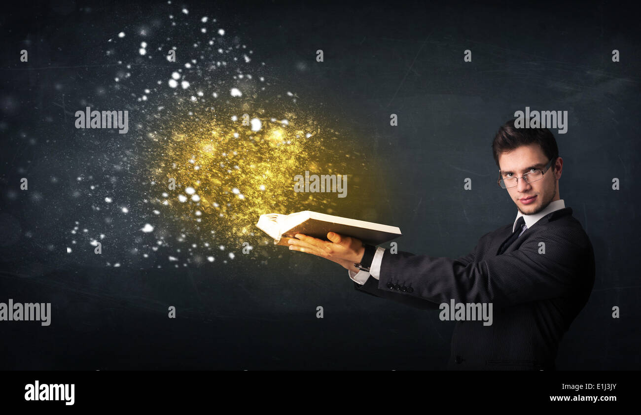 Young guy reading a magical book Stock Photo - Alamy