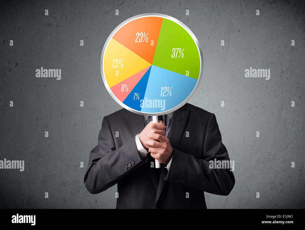 Businessman holding a pie chart Stock Photo - Alamy