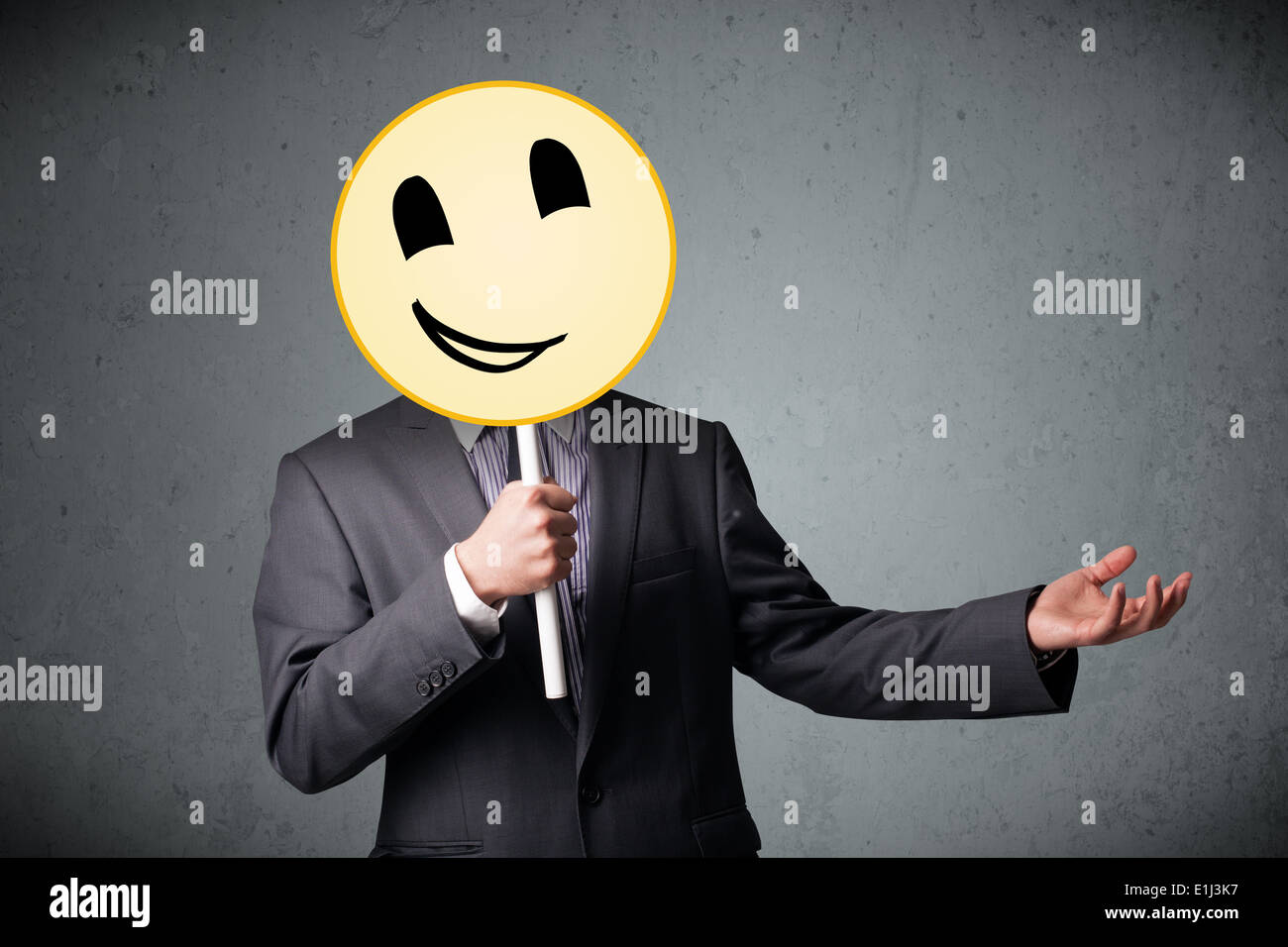 Businessman holding a smiley face emoticon Stock Photo - Alamy