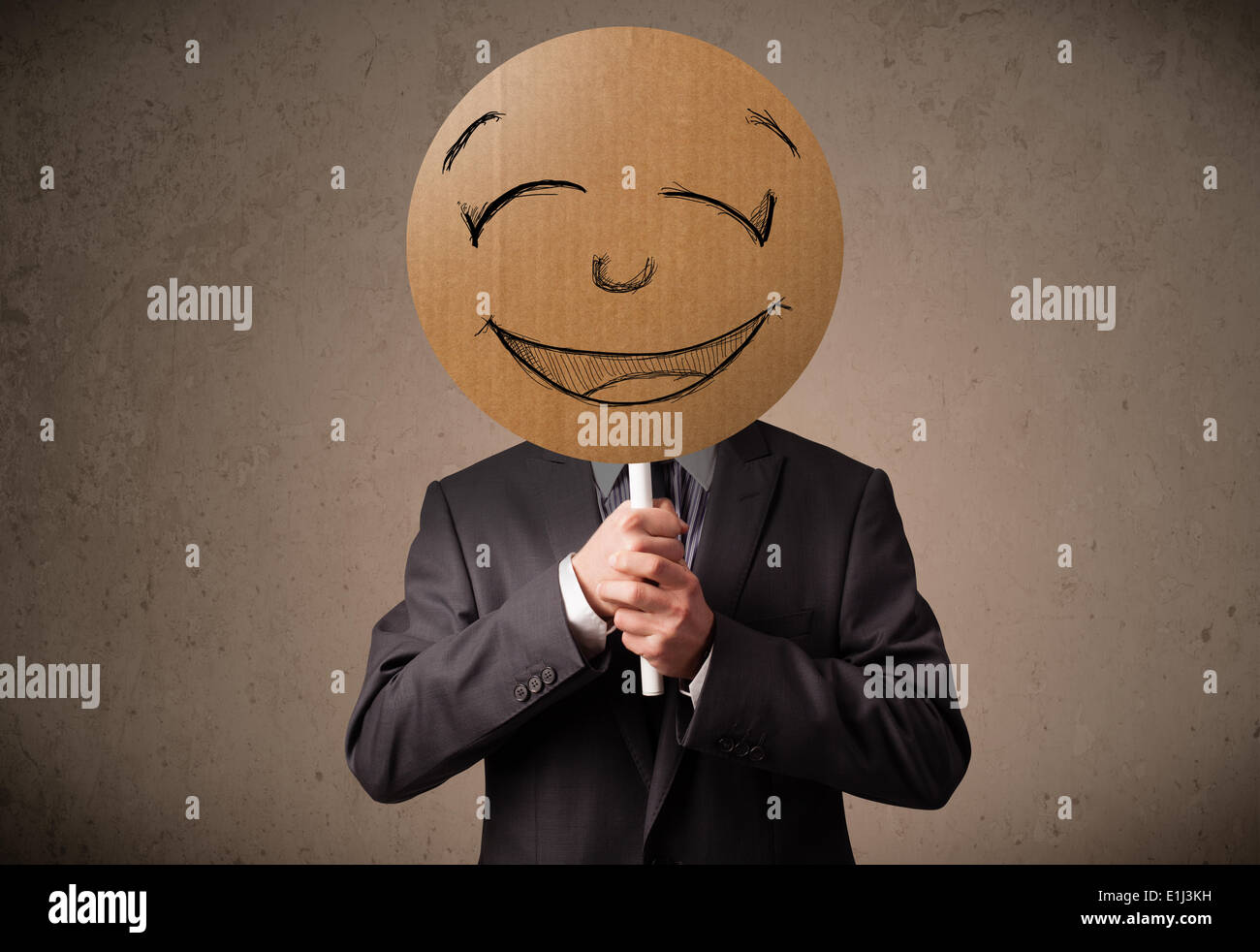 Businessman holding a smiley face board Stock Photo - Alamy