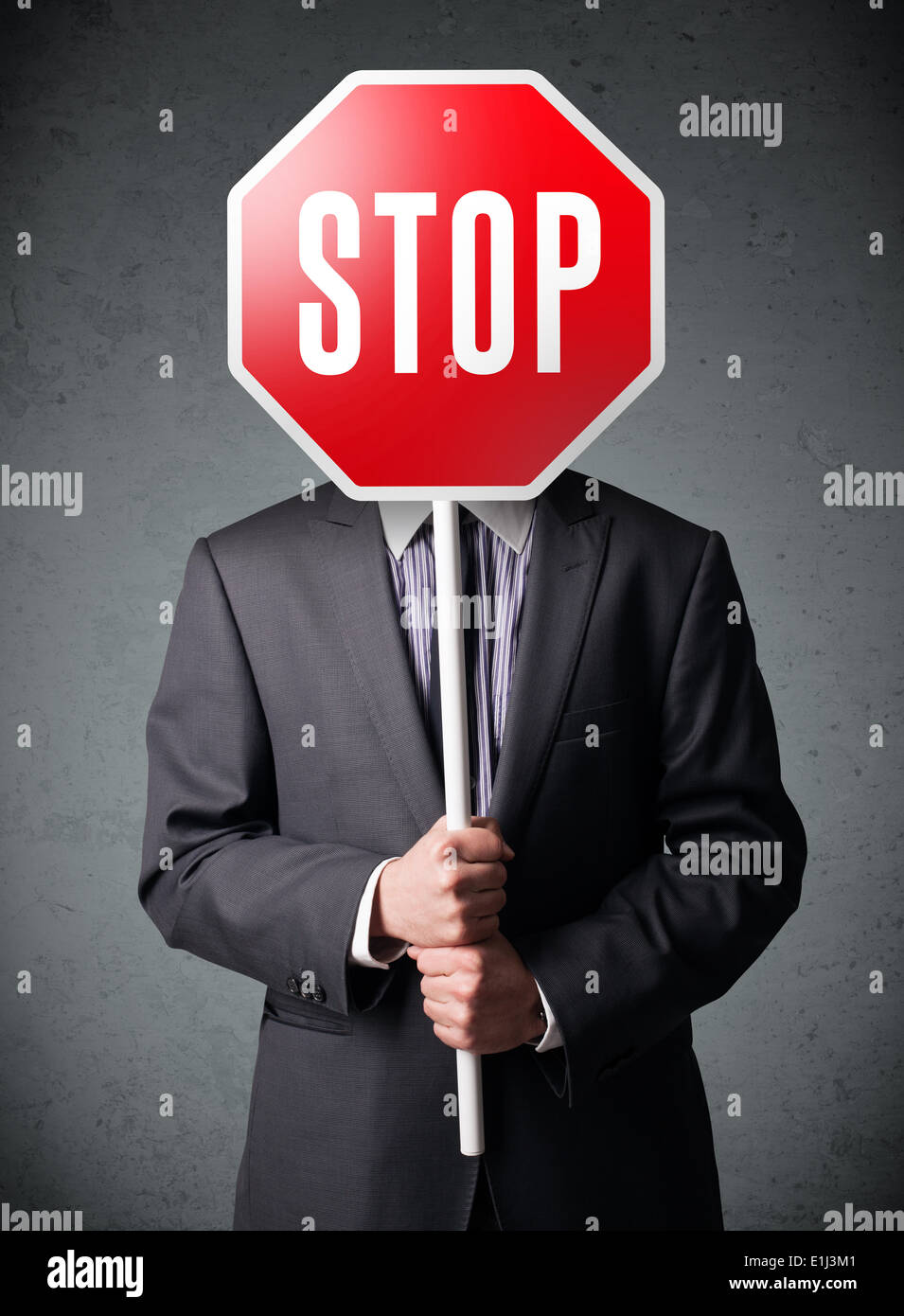 Businessman holding a stop sign Stock Photo - Alamy