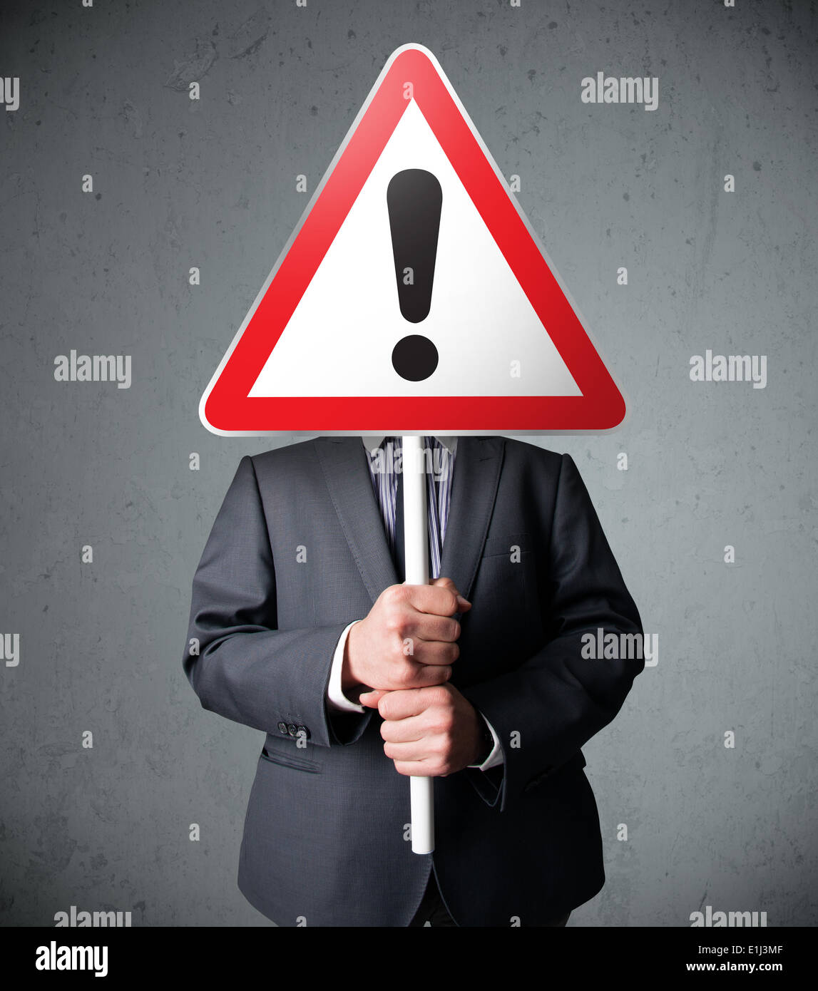 Businessman holding an exclamation road sign Stock Photo - Alamy