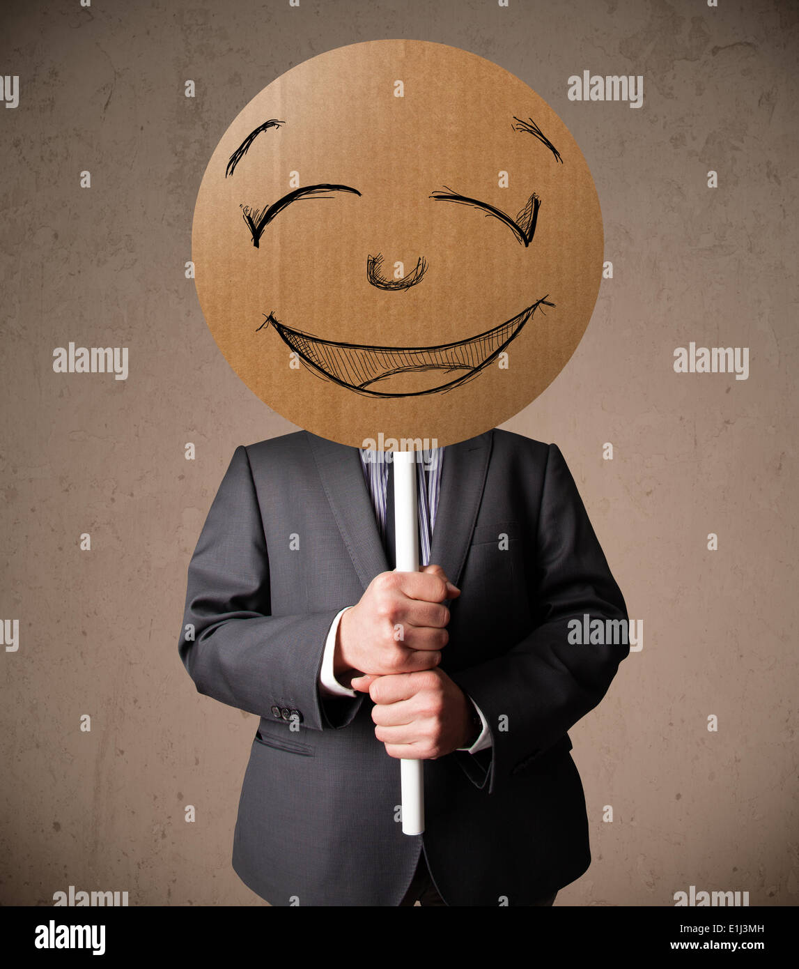 Businessman holding a smiley face board Stock Photo - Alamy