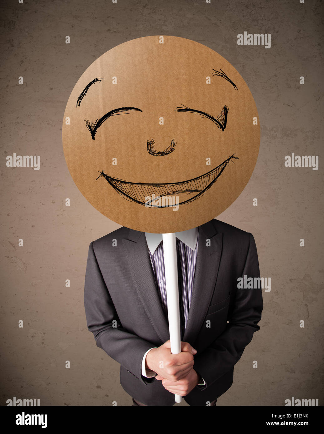 Businessman holding a smiley face board Stock Photo - Alamy