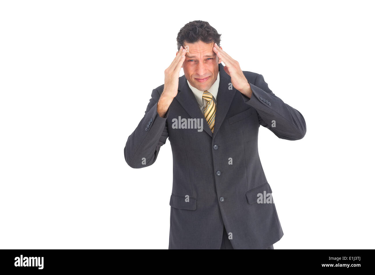 Stressed businessman with hands on head against halved world graphic on ...